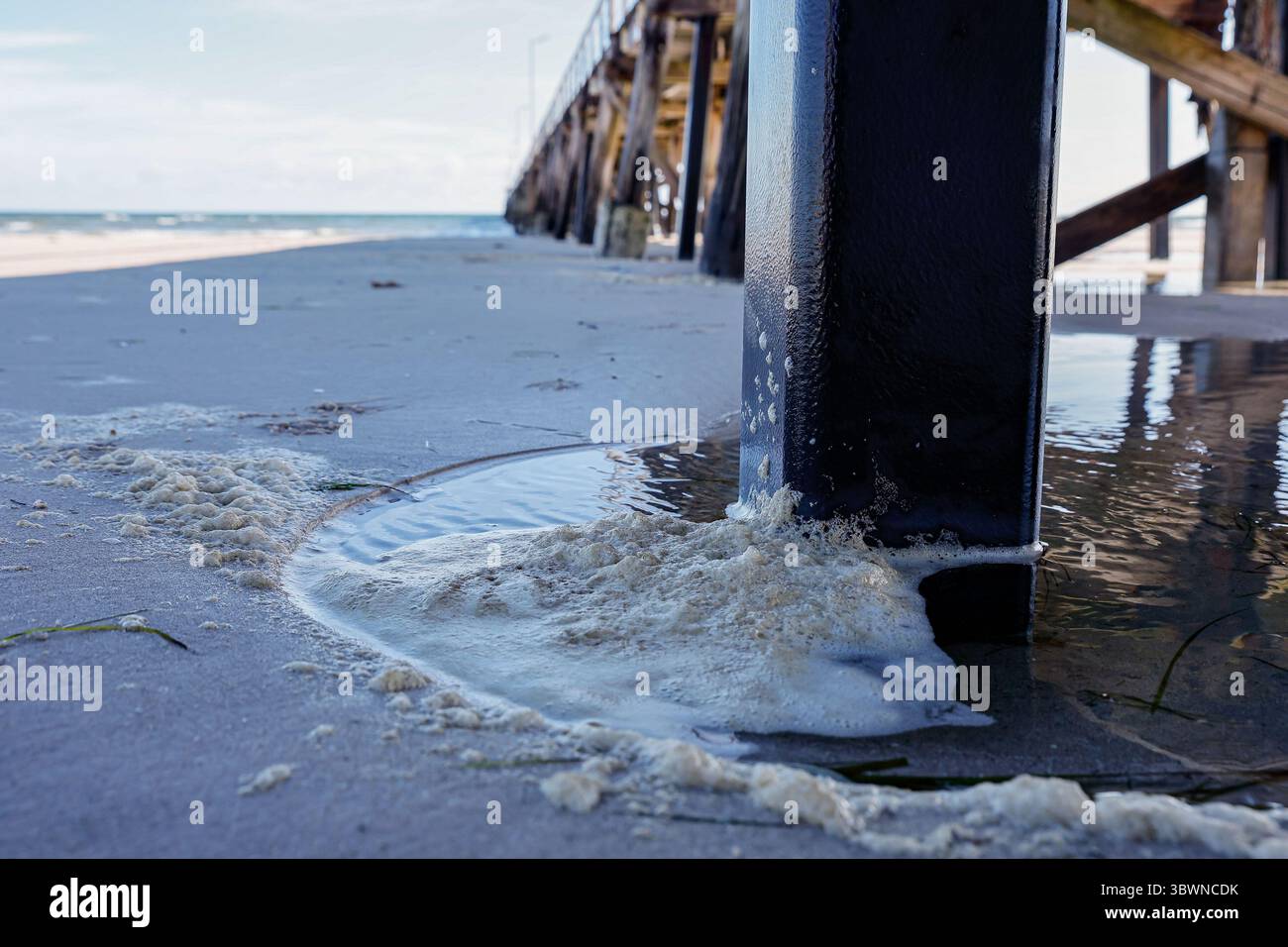 July 16, 2025, Semaphore beach, South Australia: Brown foam formed by ...
