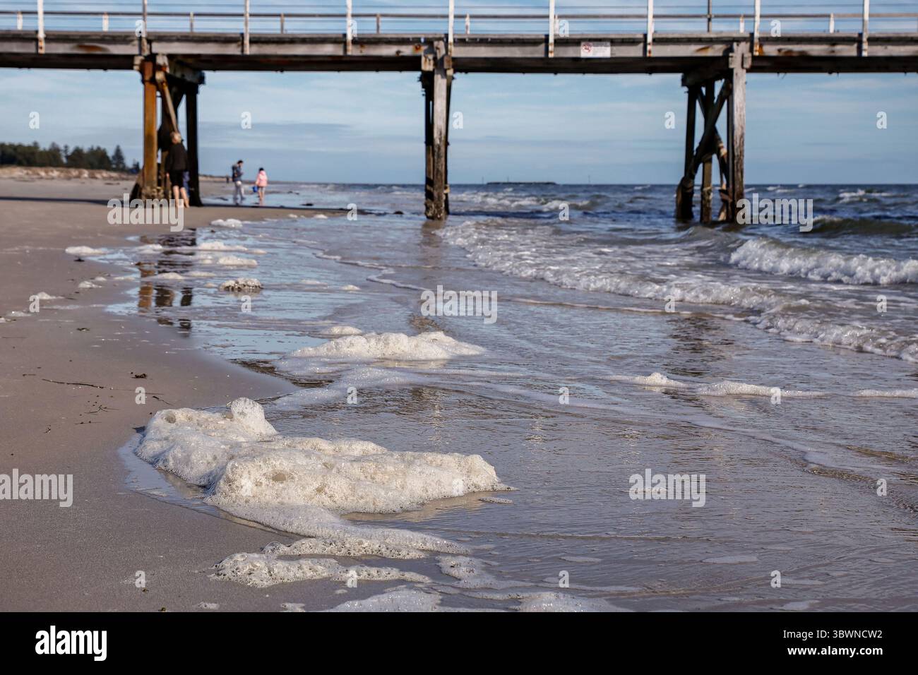 July 16, 2025, Semaphore beach, South Australia: Discoloured foam ...