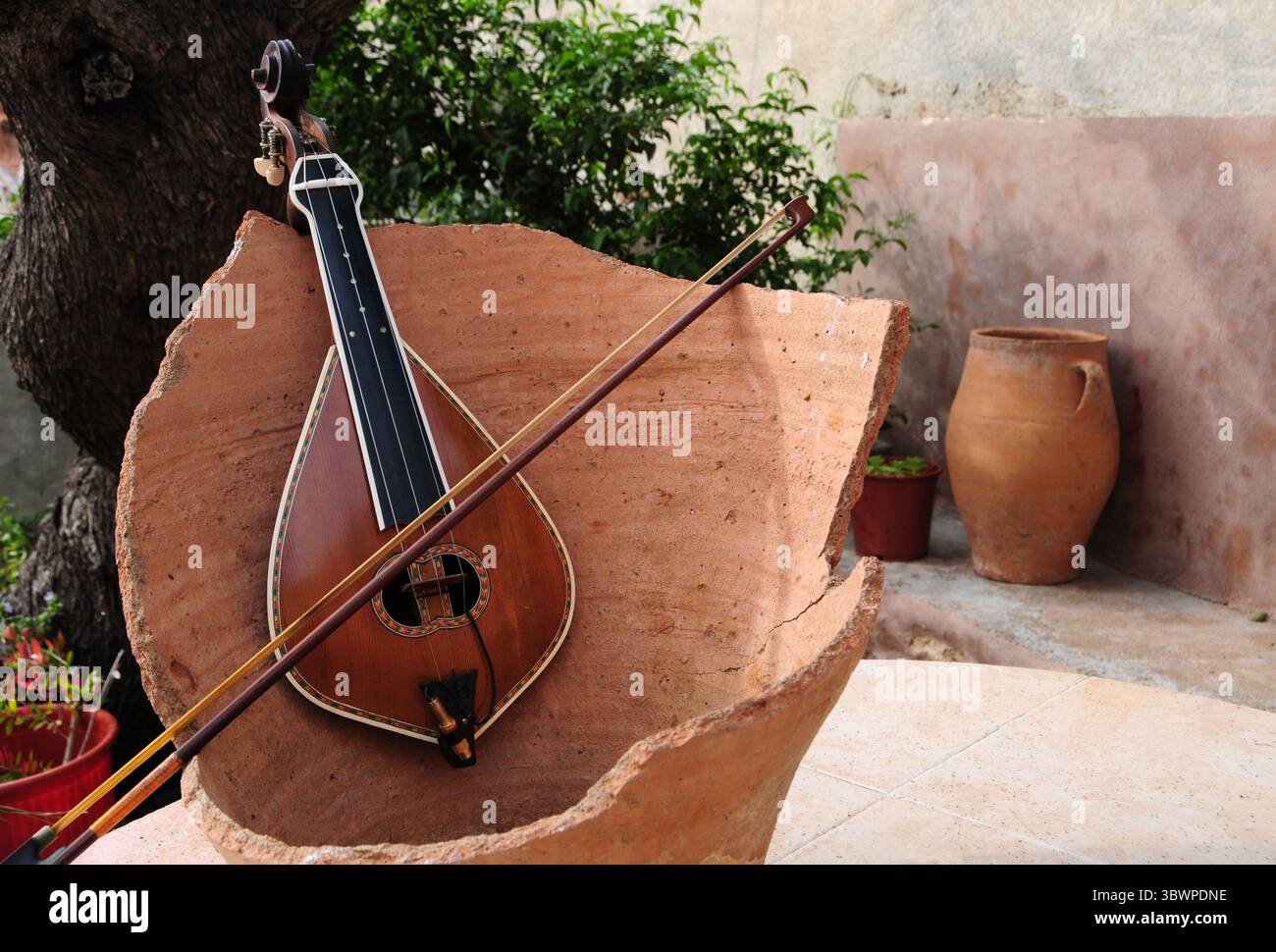 Cretan lyre with its bow, inside a broken clay jar, in the courtyard of ...