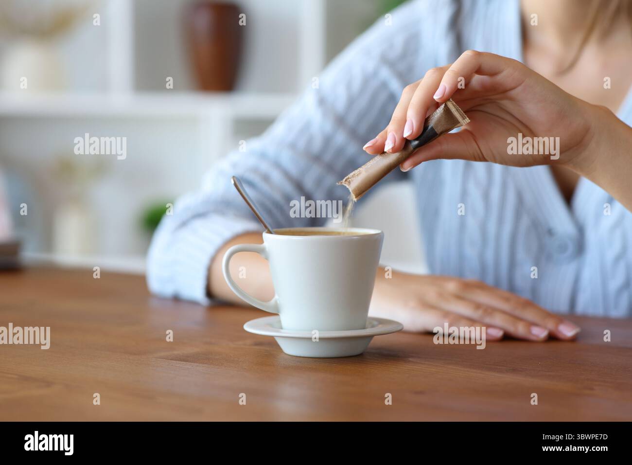 Lady adding brown sugar cup hi-res stock photography and images - Alamy