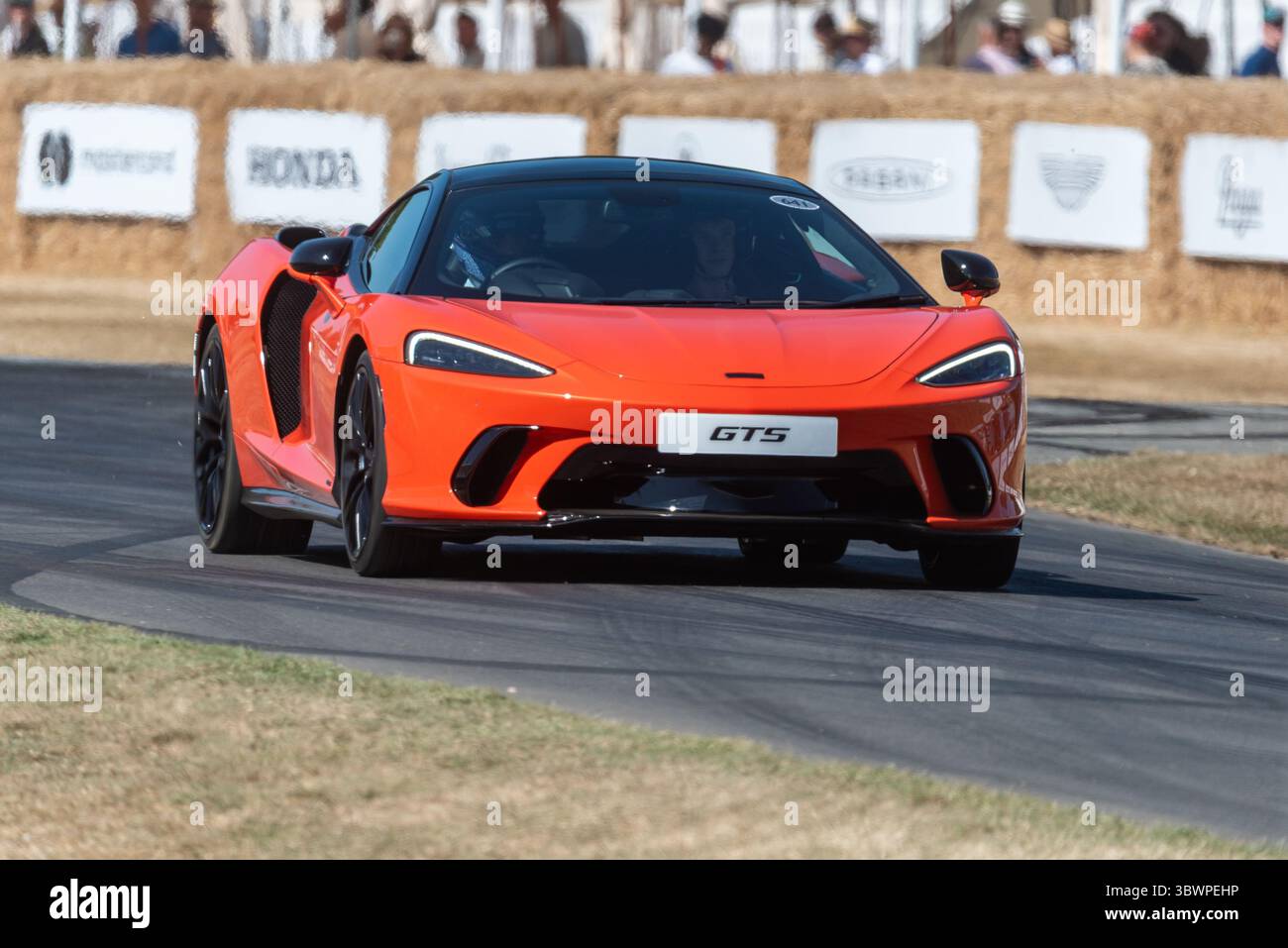 McLaren GTS grand tourer sports car driving up the hillclimb track at ...
