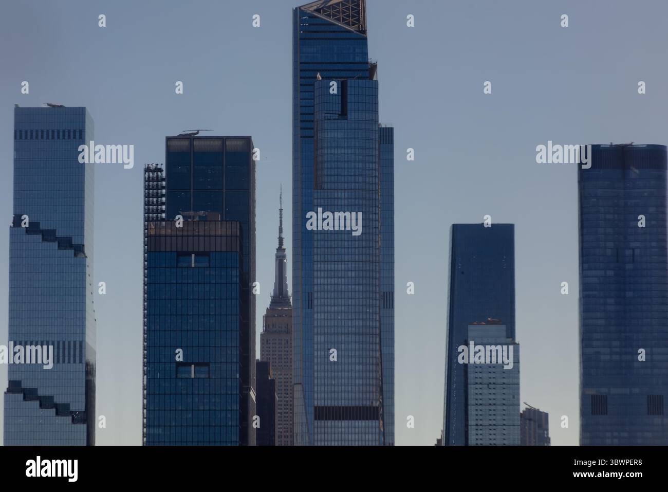 Sunlit Manhattan supertall towers and midrises rise above the Hudson ...