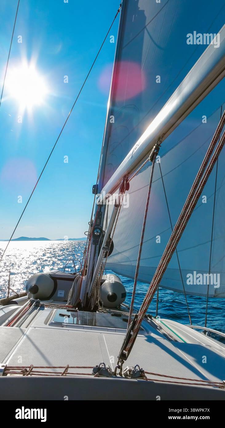 Sailing yacht cruising under full sail on a sunny day. View from the ...