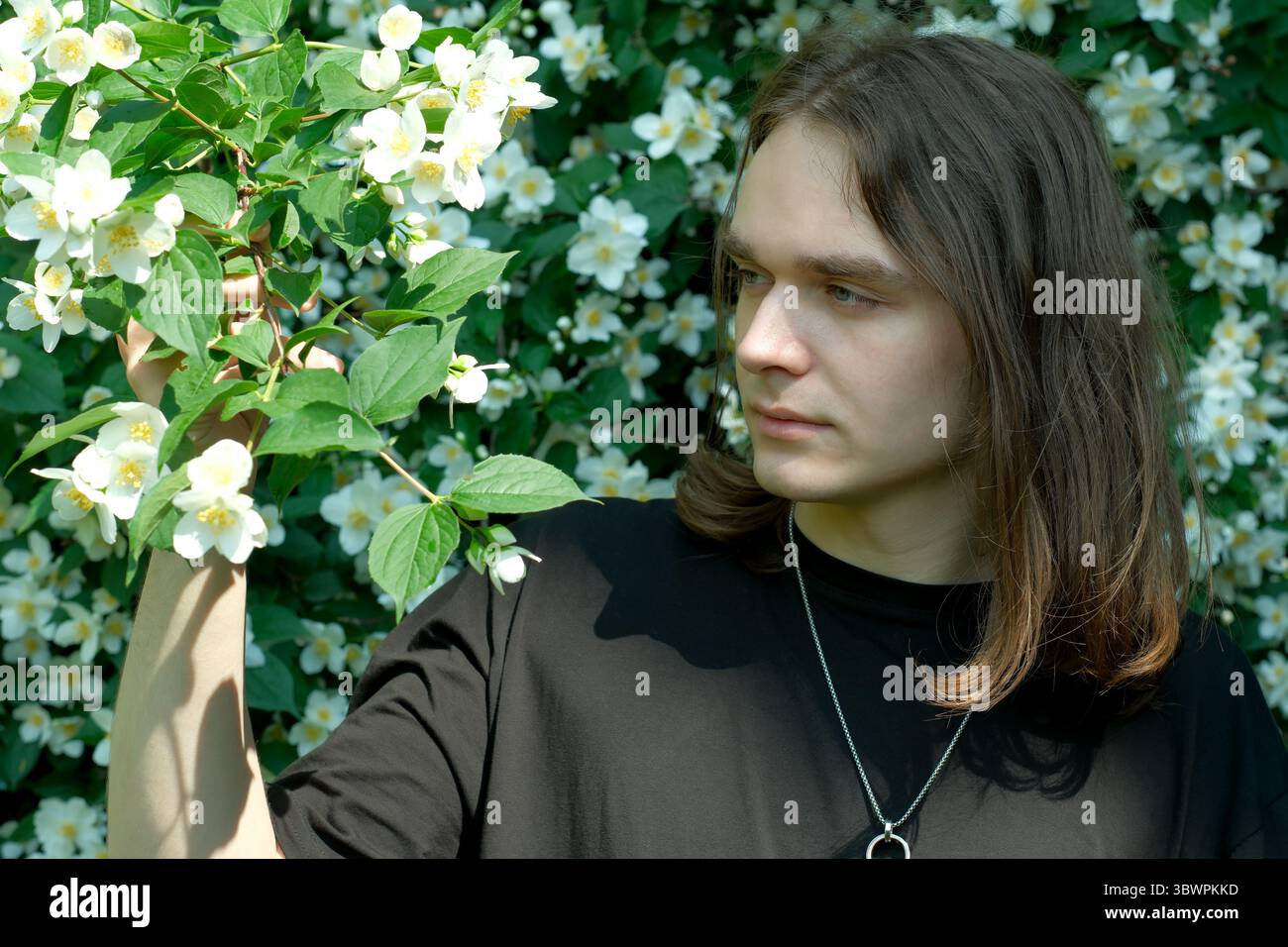 Young man admires flowers hi-res stock photography and images - Alamy