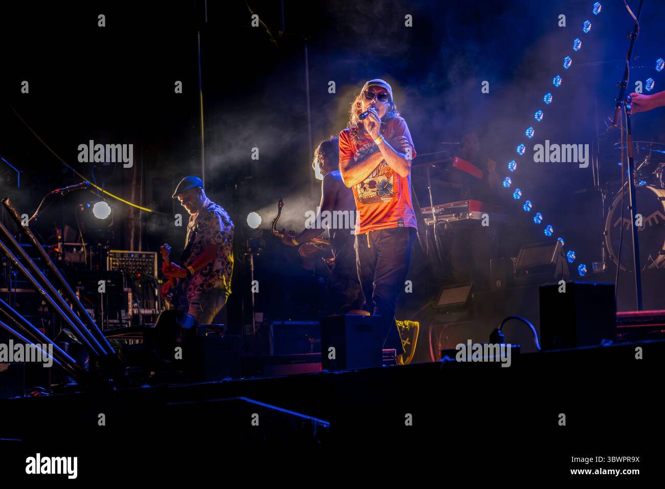 Lead Singer Engaging Crowd On Stage Under Vibrant Red Stage Lighting ...