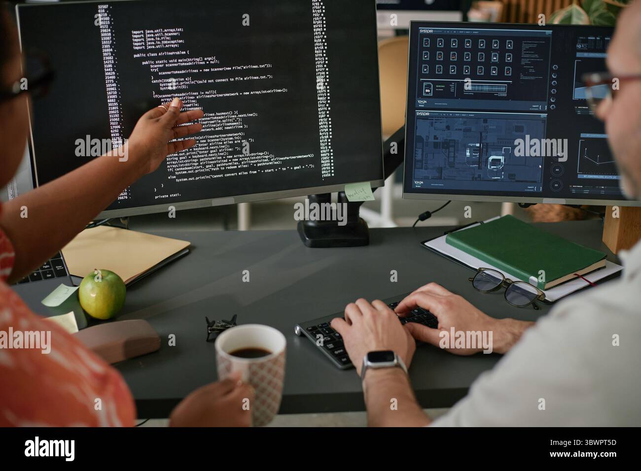 Caucasian middle aged man and Black woman collaborating at workstation ...
