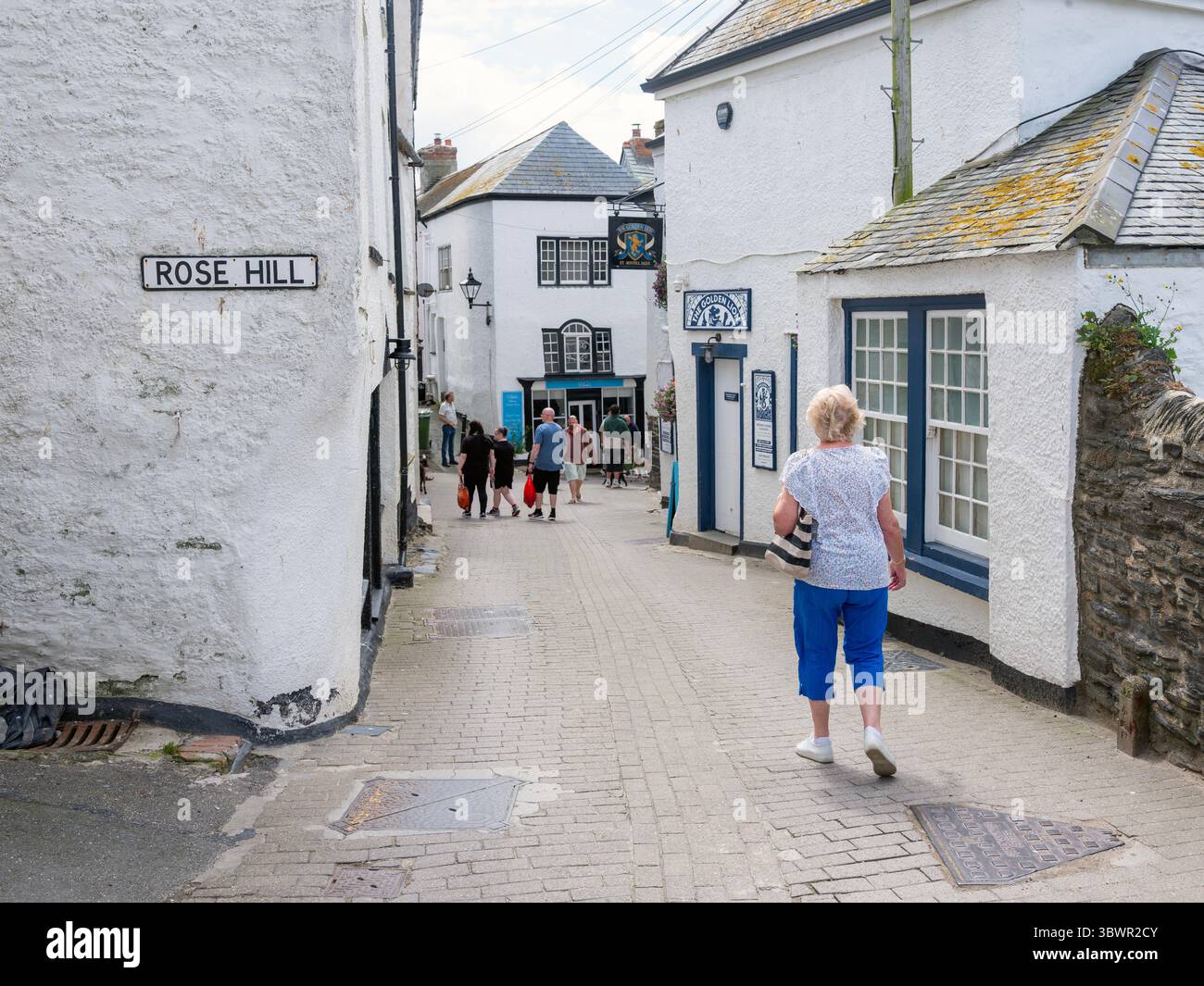 port isaac, england, 22 june 2025: old white houses and tourists in ...