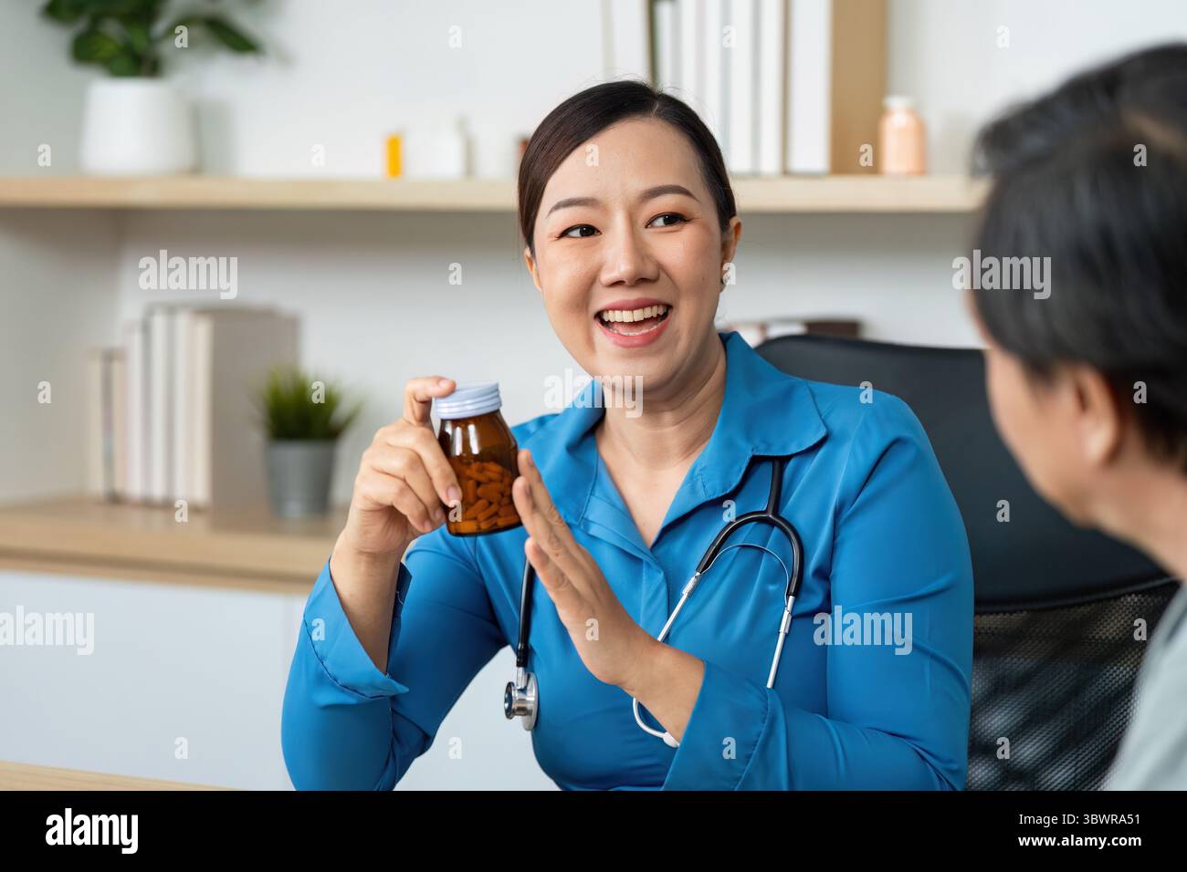 Doctor discussing medication with a patient in a healthcare setting ...