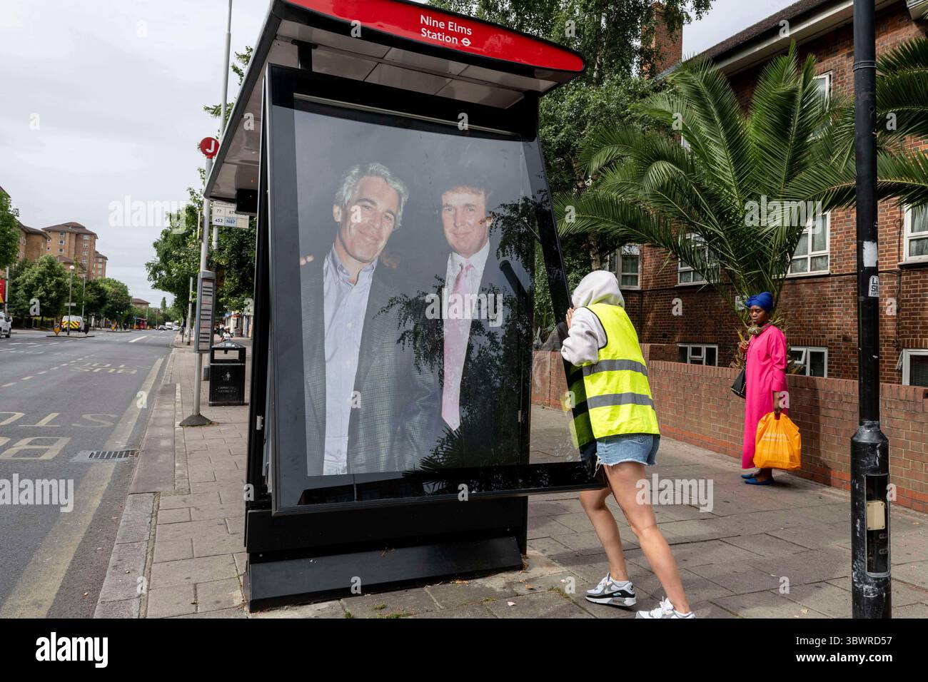Activists put up a poster showing President Donald Trump and Jeffrey ...