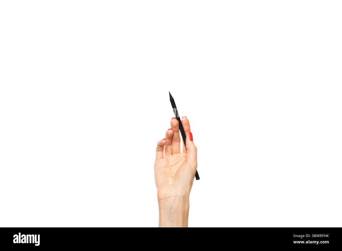 Close-up Female hand writing with a pencil, black wooden pencil in hand ...