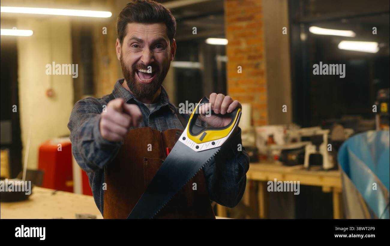 Carefree Caucasian handyman male craftsman man builder guy fooling ...