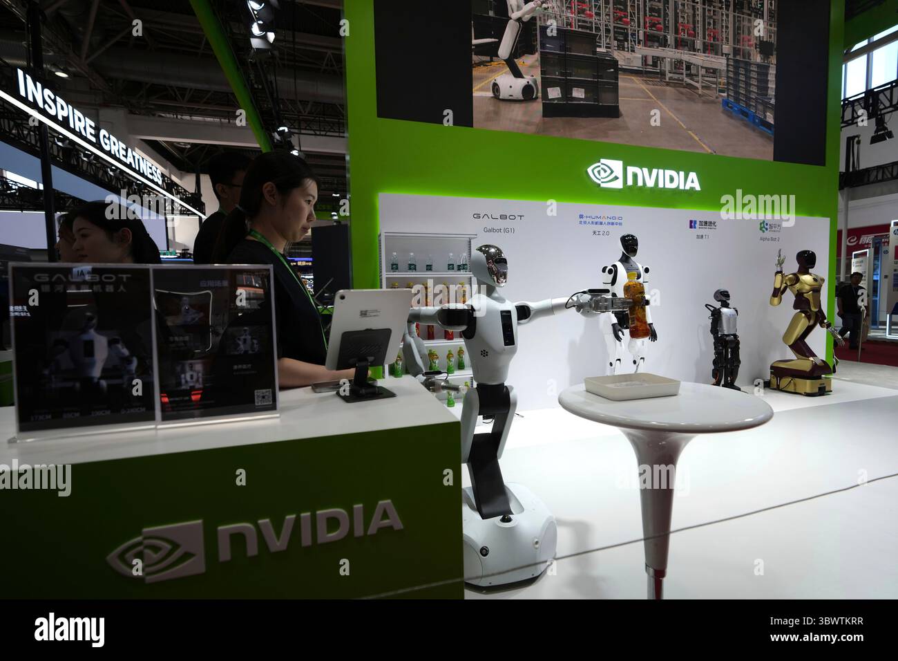 A robot at Nvidia's exhibition booth performs offering a soft drink ...