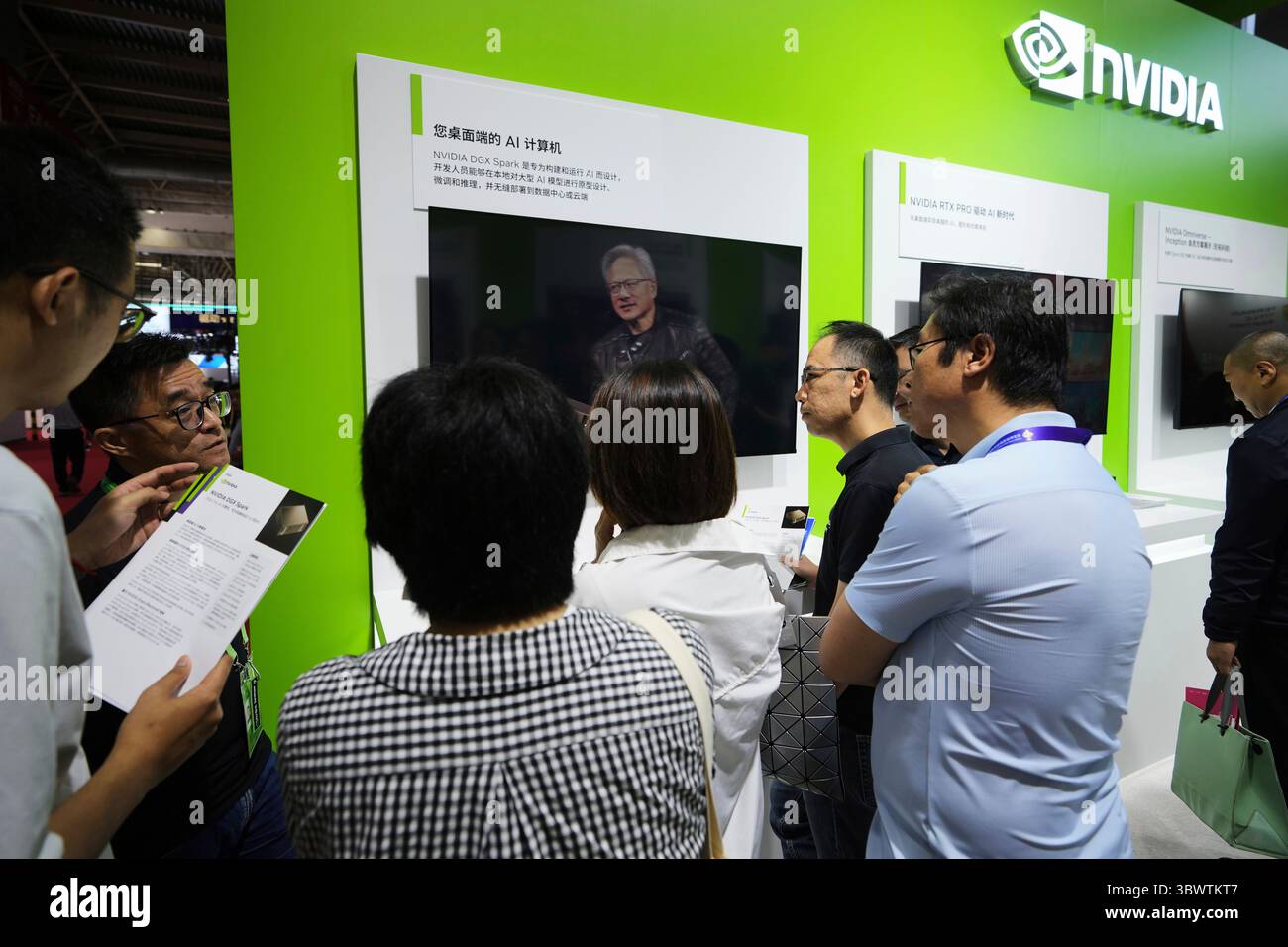 An exhibitor introduces the Nvidia DGX Spark to visitors at the Nvidia ...