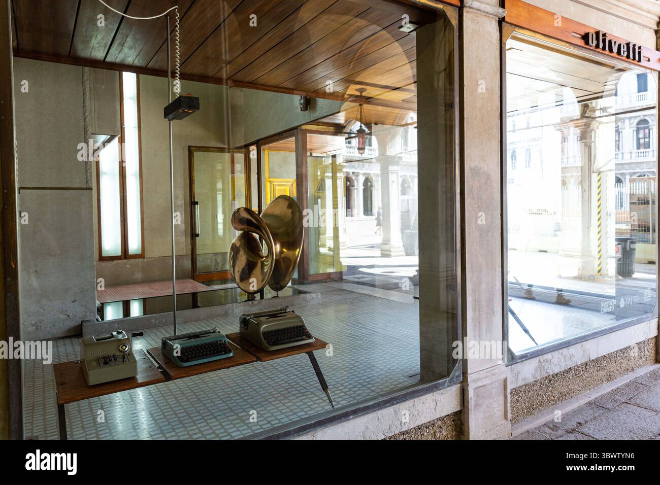 Showcase of the Olivetti shop. On display are three typewriters and a ...