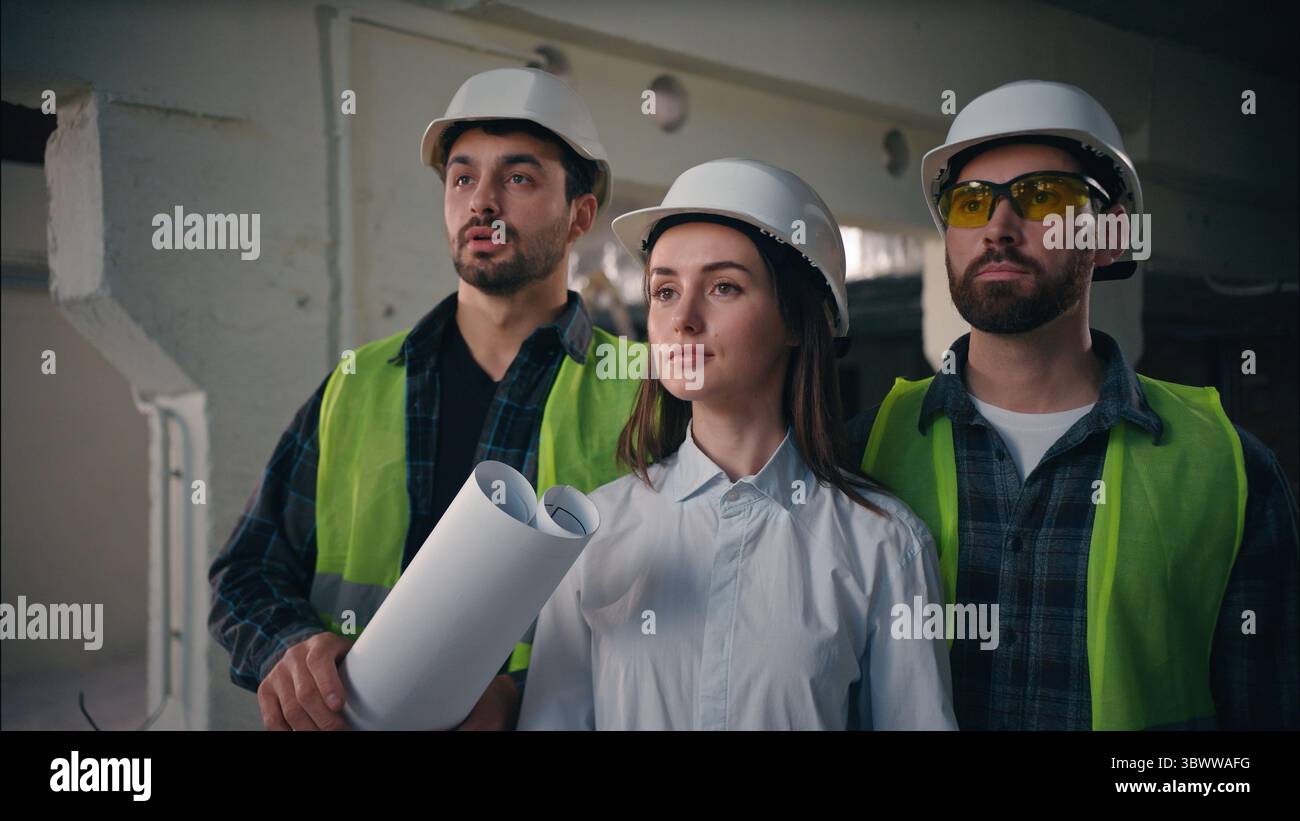 Surprised Caucasian builders woman men working inspect building in ...