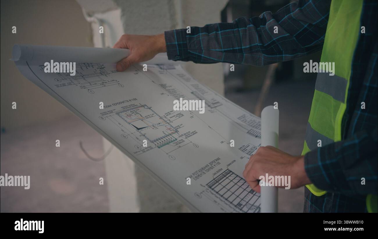 Caucasian man architect holding draft plan builder handyman work. The ...