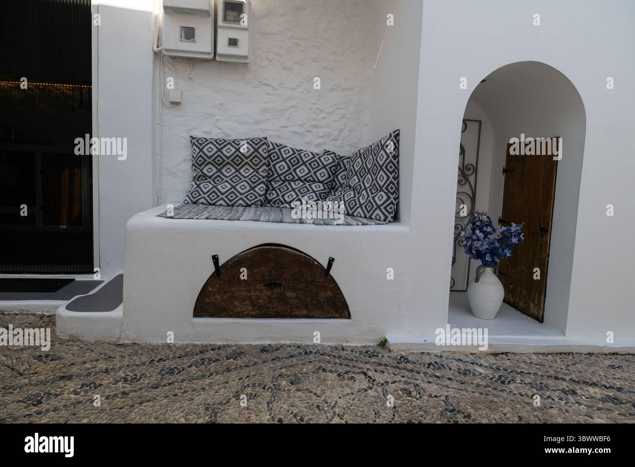Featuring geometric black-and-white cushions, a rustic half-circle ...
