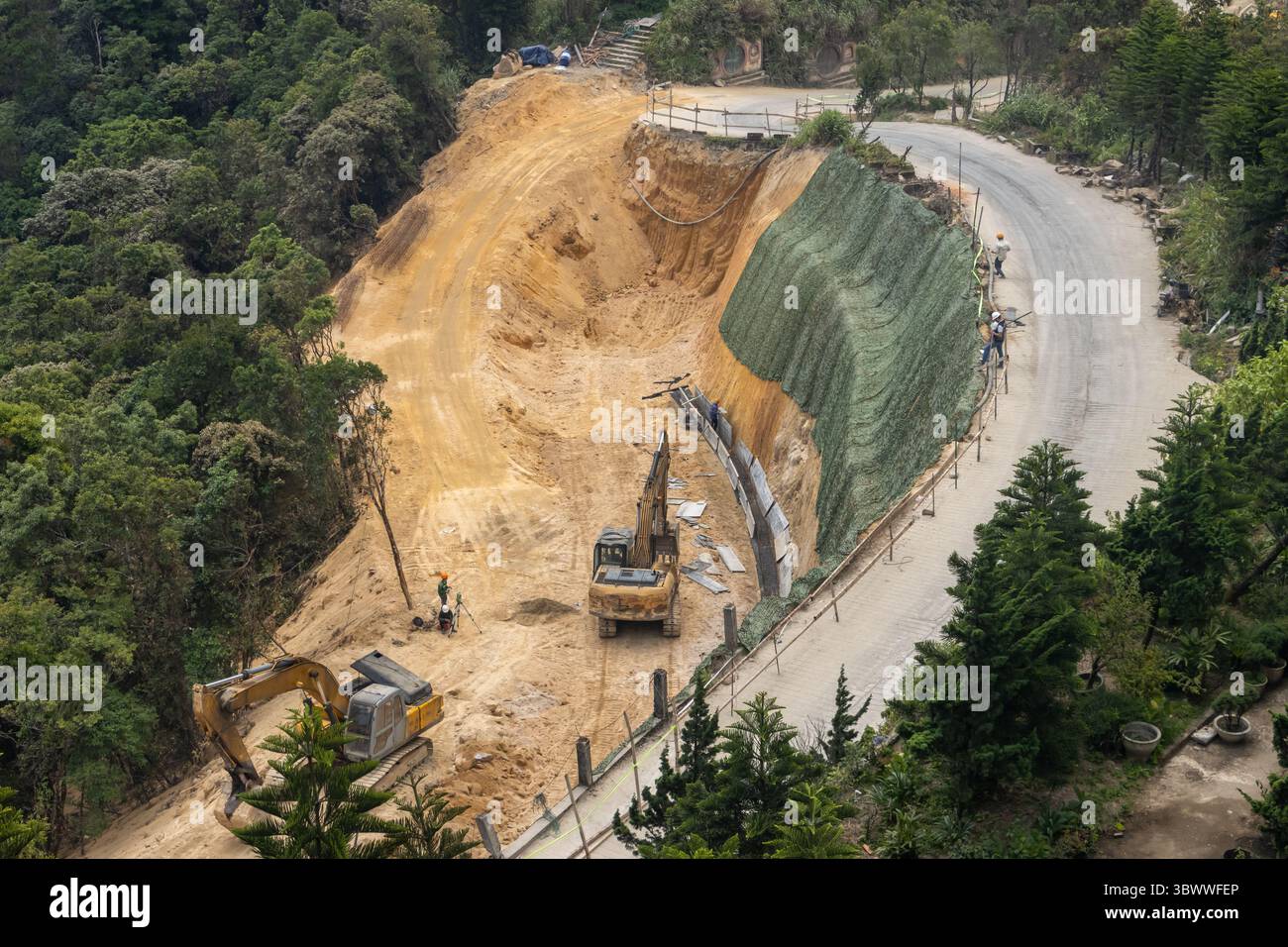 Construction site in a mountain area with a diggers and a retaining ...