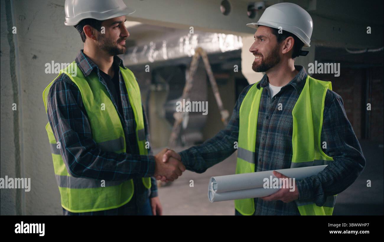 Technicians discussing blueprint construction project hi-res stock ...