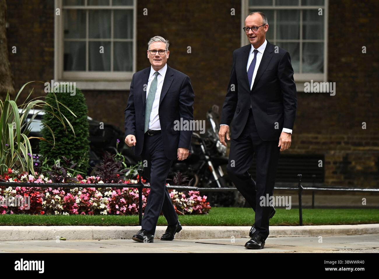 German Chancellor Friedrich Merz, right walks with Britain's Prime ...