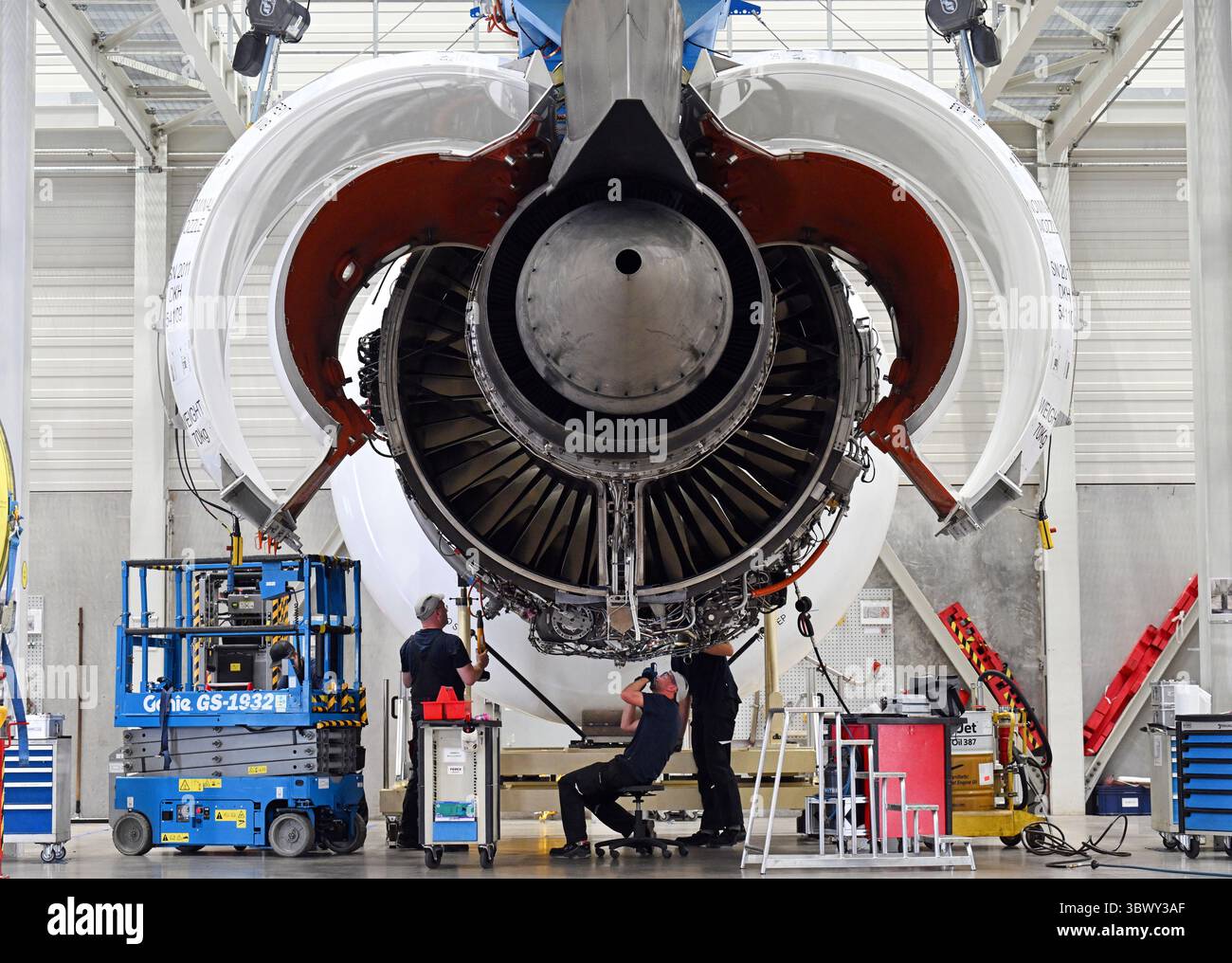 17 July 2025, Thuringia, Arnstadt: Employees work on a Trent XWB engine ...