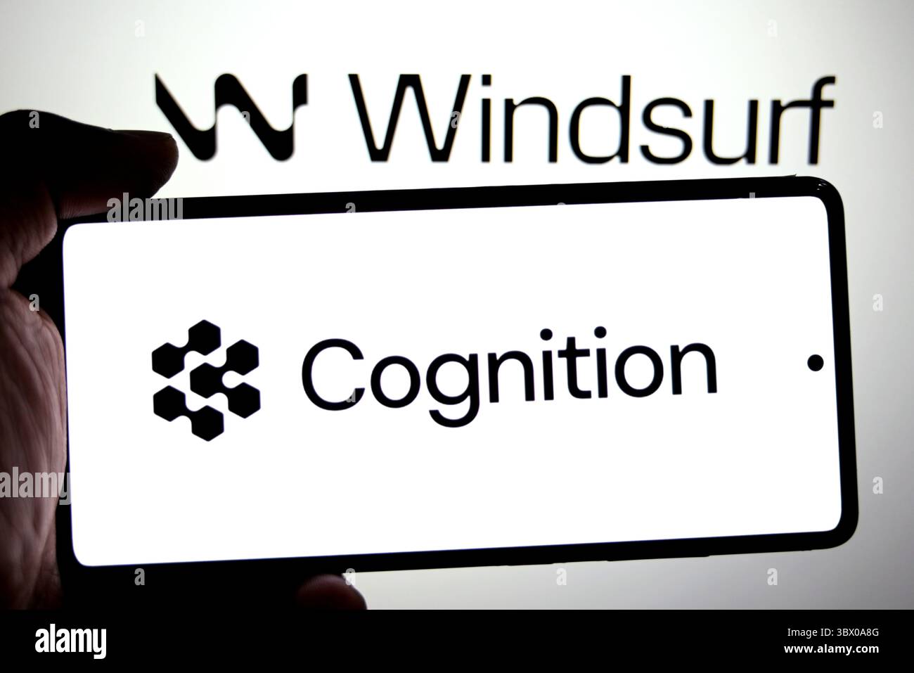 In this photo illustration, a Cognition logo is seen displayed on a smartphone with a Windsurf ...
