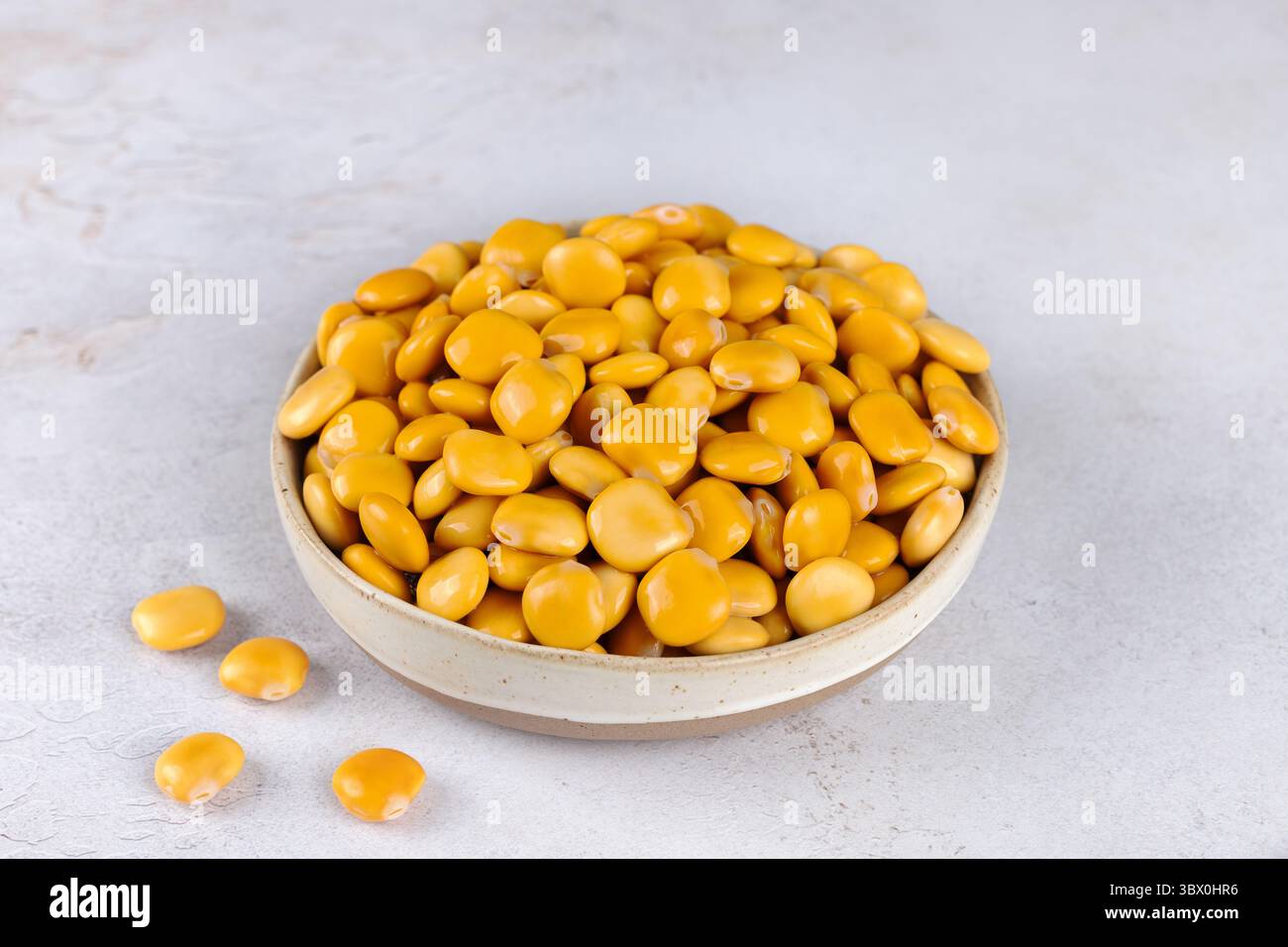 Pickled yellow lupin beans on a white background. High protein plant ...