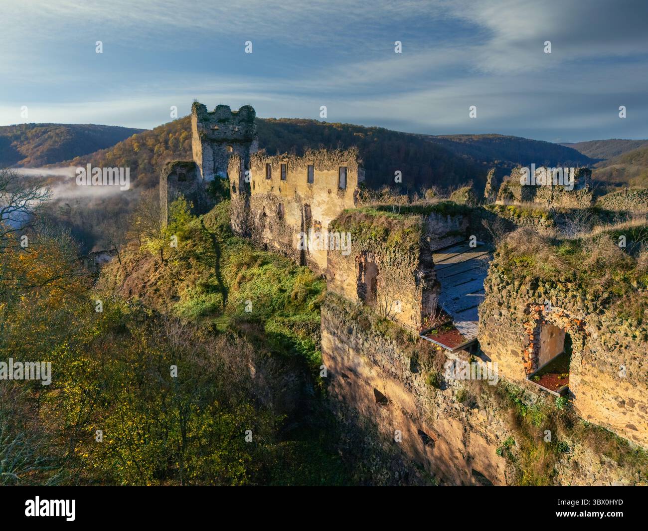 Aerial view of the weathered stone ruins of Čabraď Castle stand proudly ...