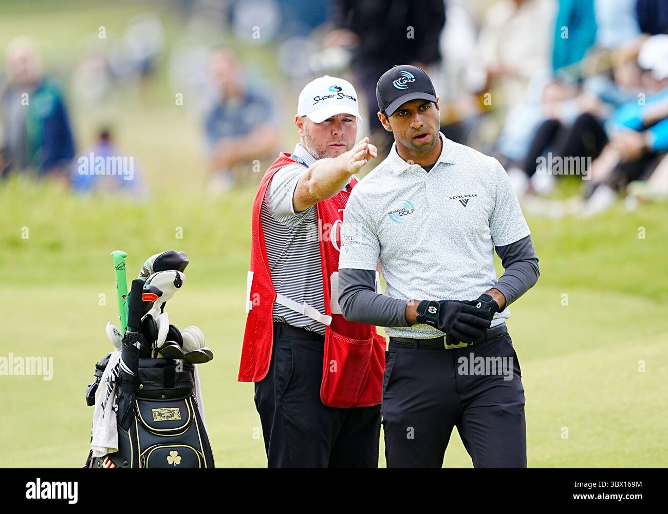 Caddie Jason Timmis and England's Aaron Rai on the 10th green on day ...