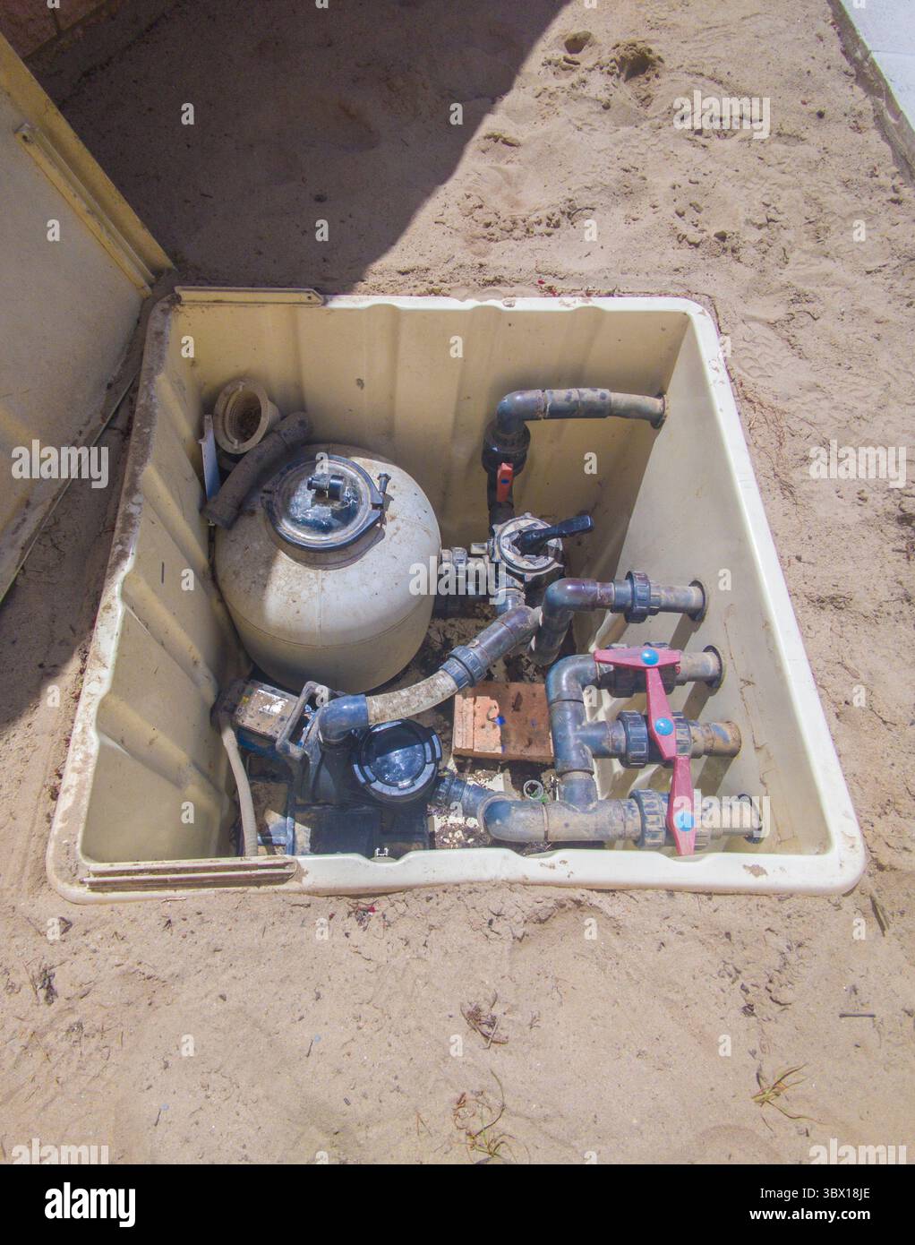 Buried mounted sewage treatment box. Beach sand covered surface Stock ...