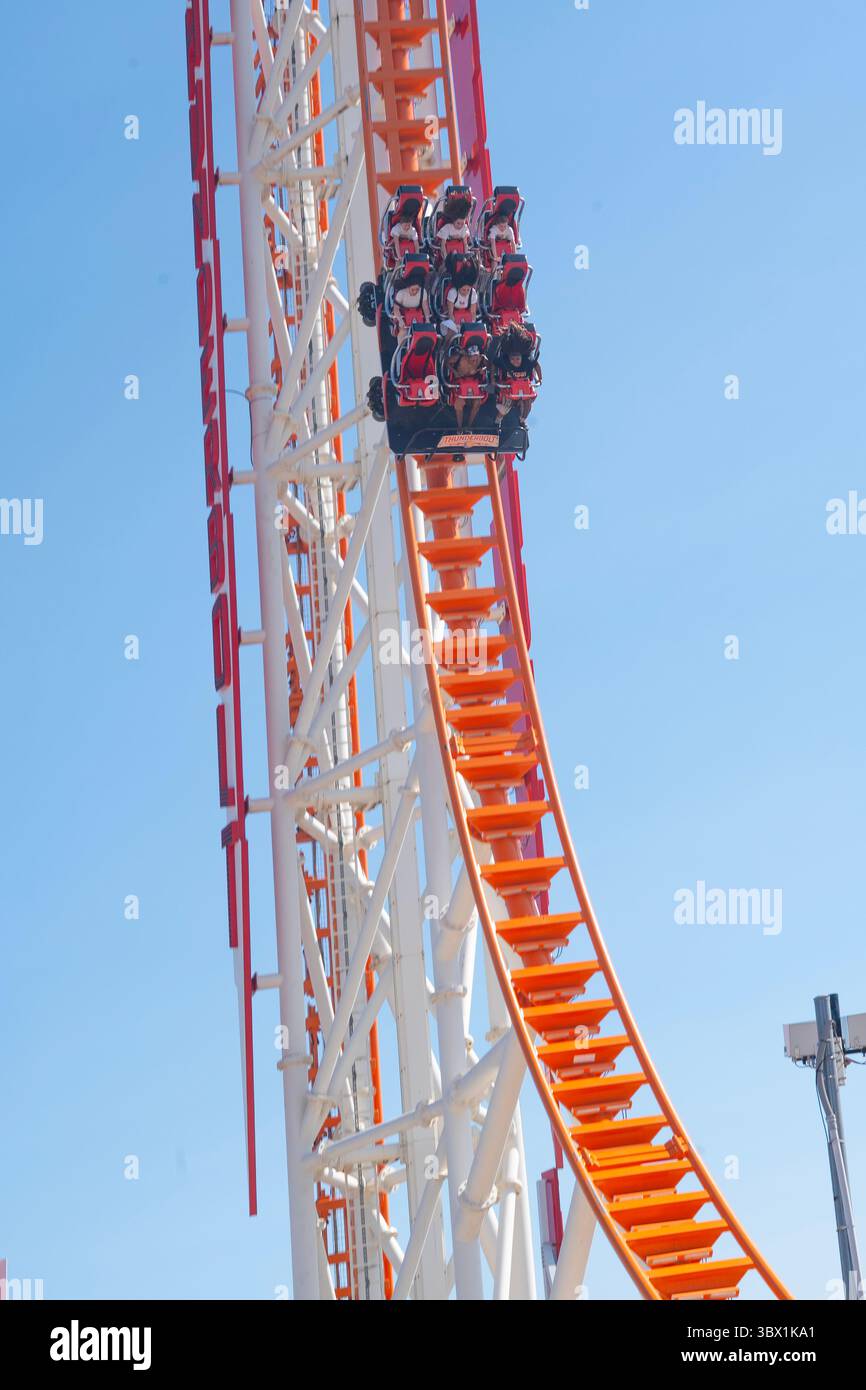 People have a thrilling ride on the fast moving Thunderbolt Roller ...