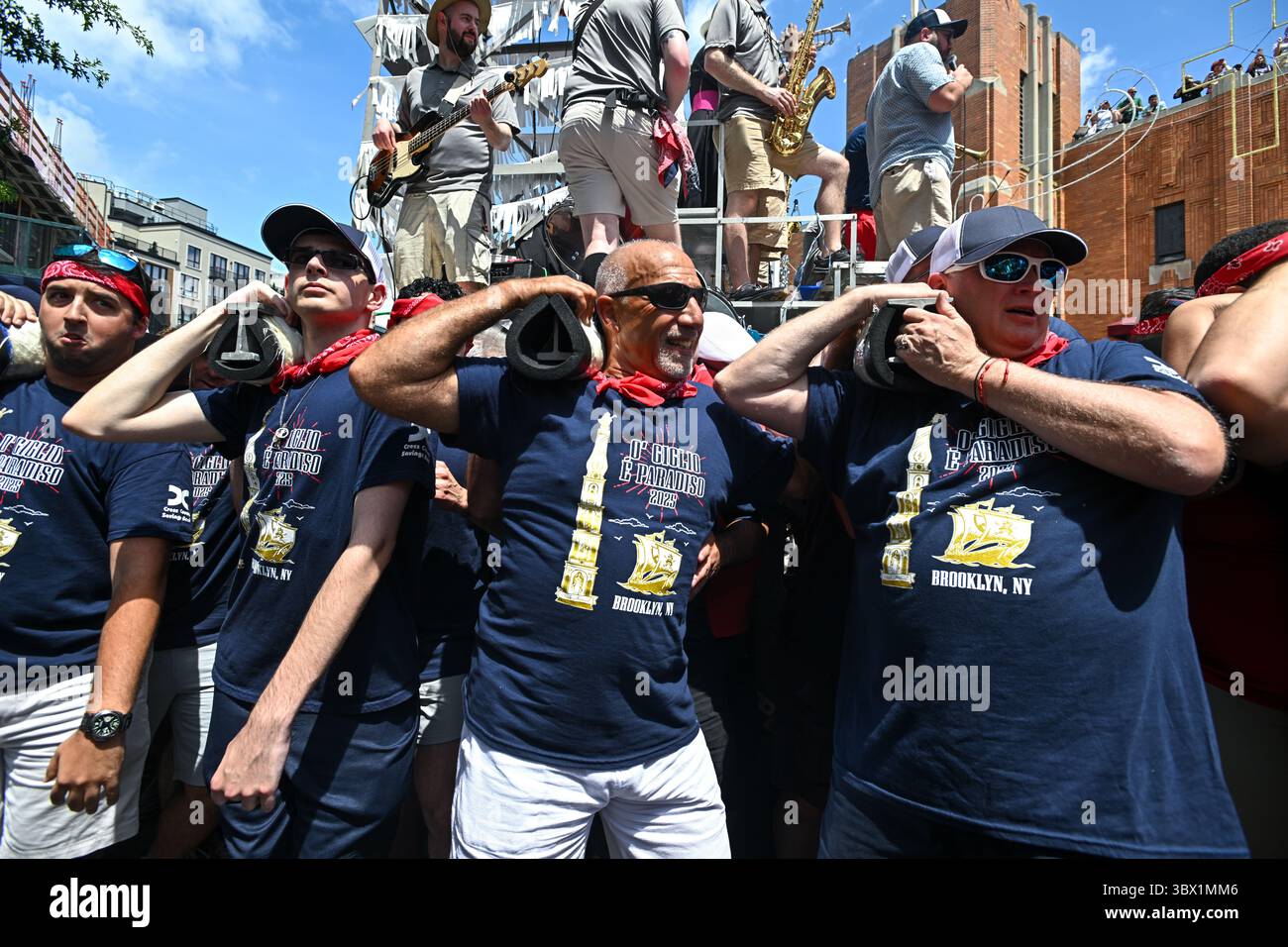 Lifters carry a 80-foot tall, 4-ton Giglio tower near the Shrine Church ...