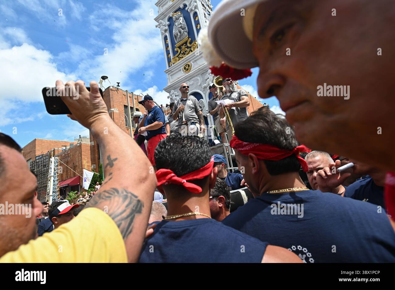 Lifters carry a 80-foot tall, 4-ton Giglio tower near the Shrine Church ...