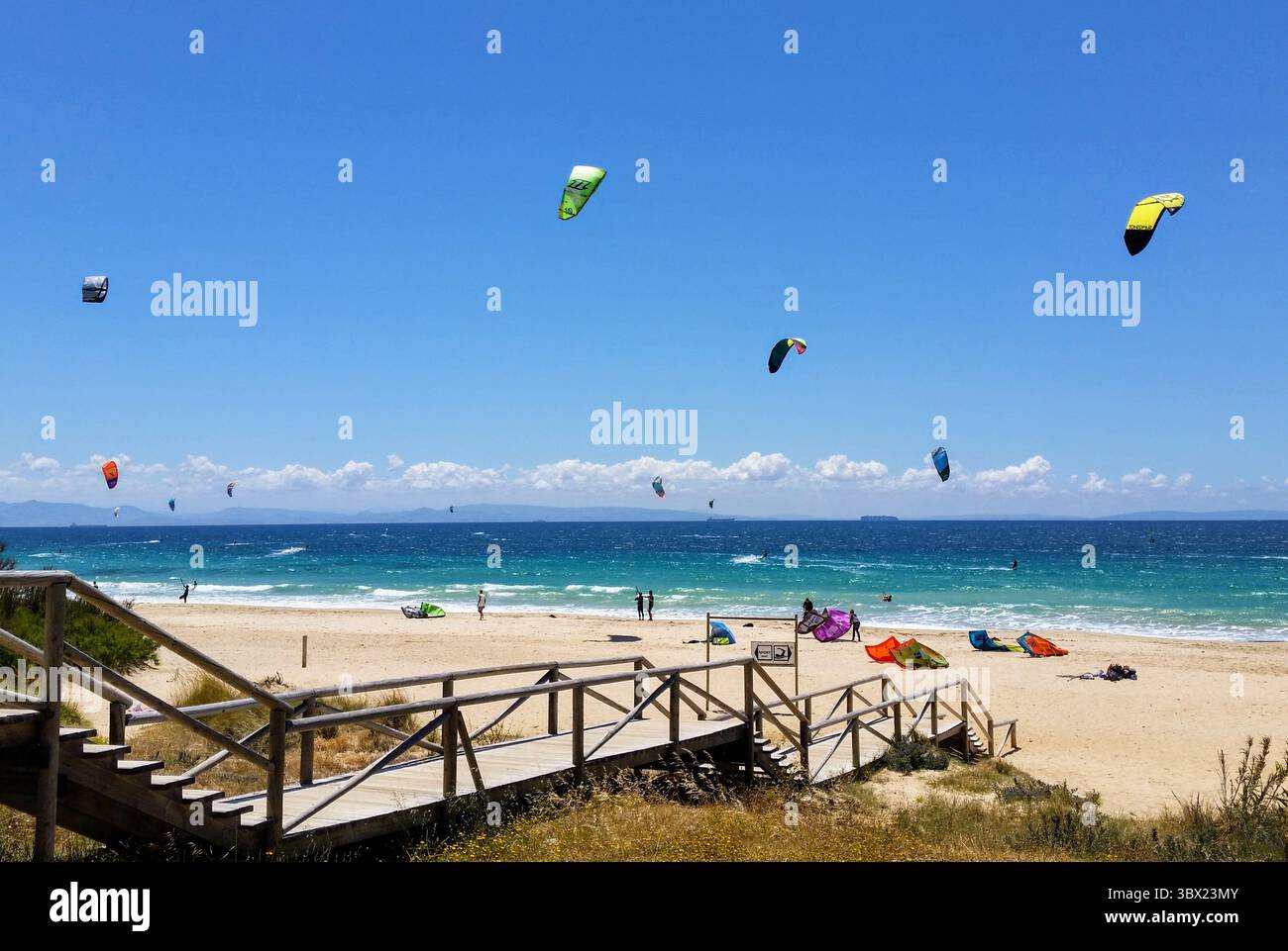 Colorful kitesurfing scene in Tarifa Spain with kites in the water and ...