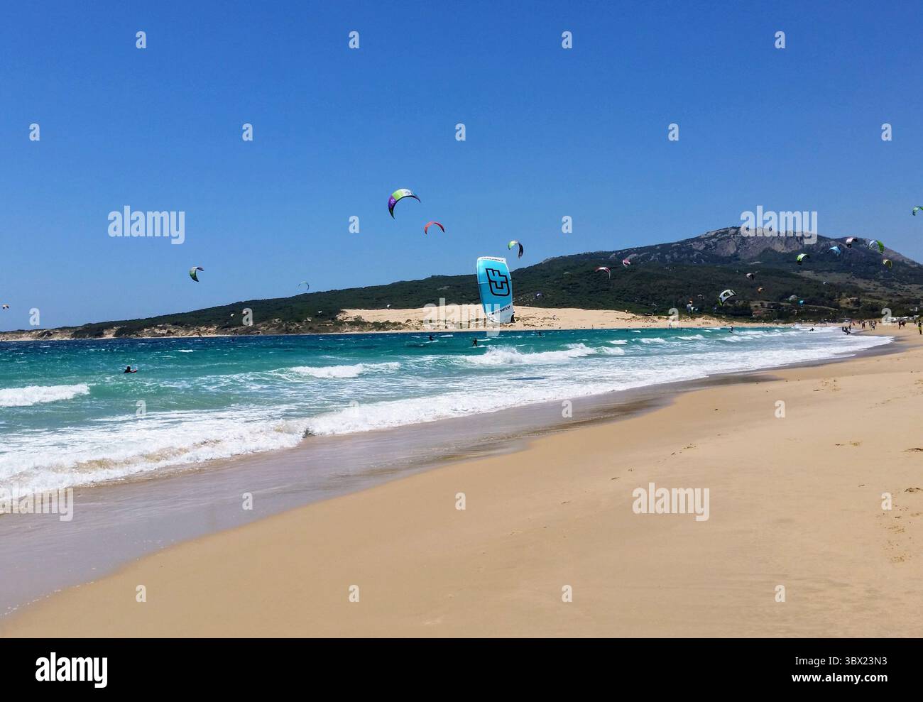 Colorful kitesurfing scene in Tarifa Spain with kites in the water and ...