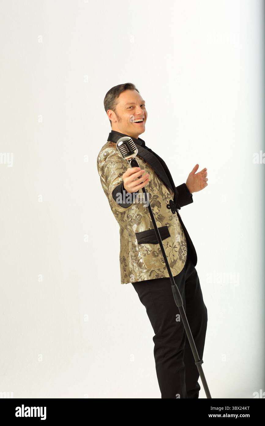 Italian singer Tiziano Ferro with a boom microphone and a gold jacket ...