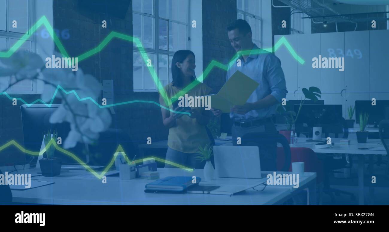 Collaborating professionals reviewing documents in open plan office ...