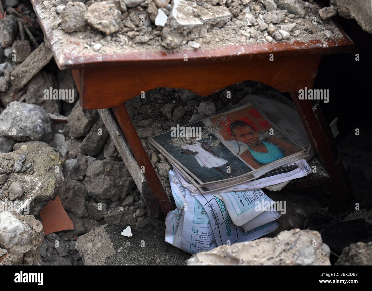 August 19, 2021, Les Cayes, Haiti: Family photos lie in the rubble as ...