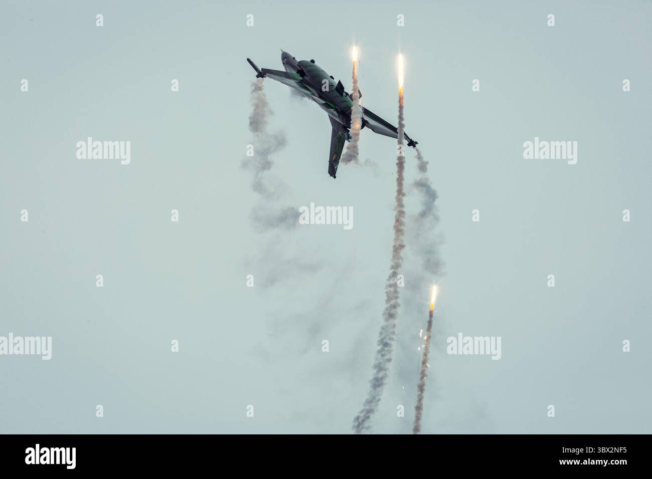 jet fighter shooting fire flares rockets with sparks. Airplane ...