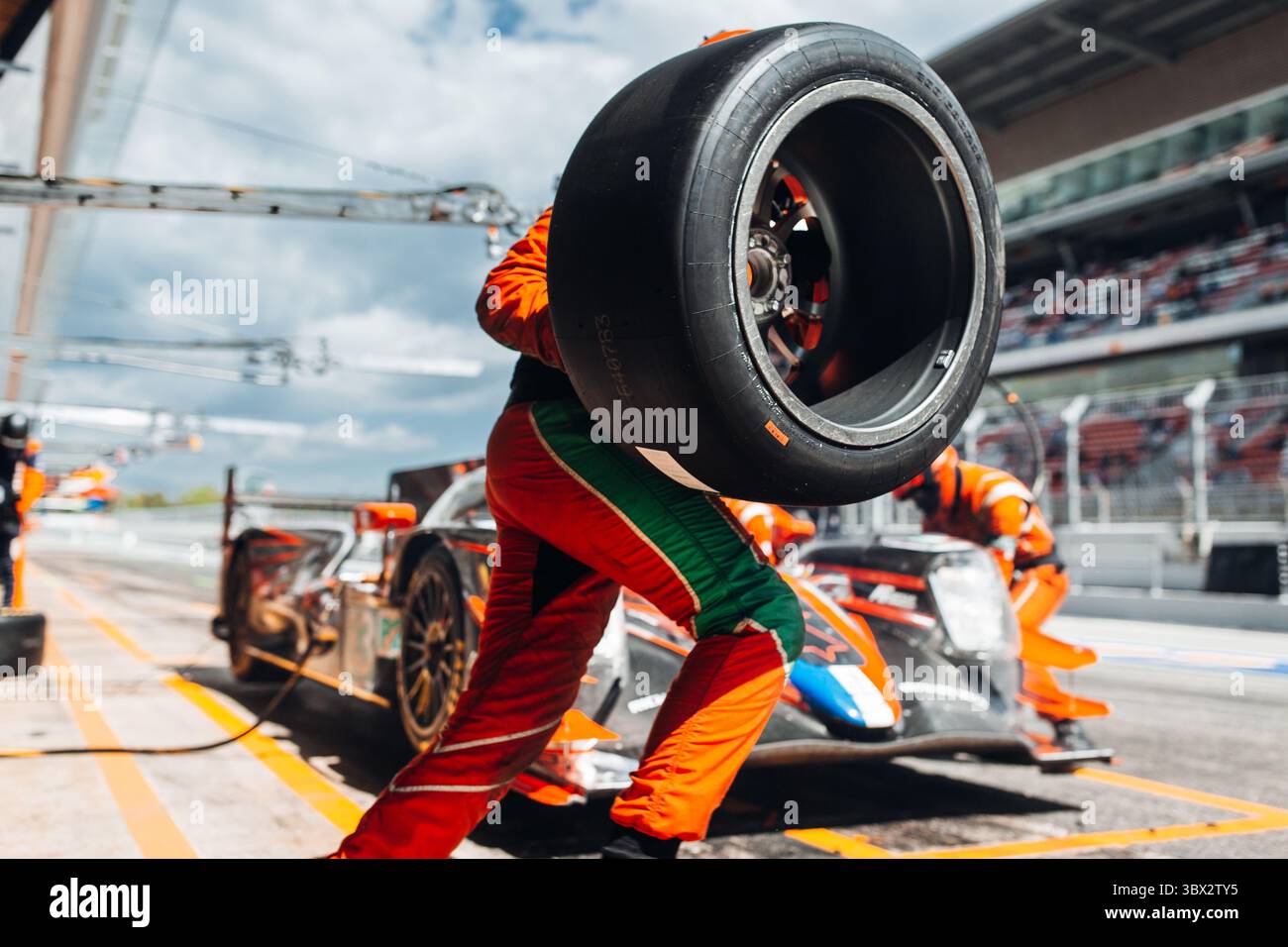 Team Mechanics refuel During a High-Speed Pit Stop in the Midst of an ...