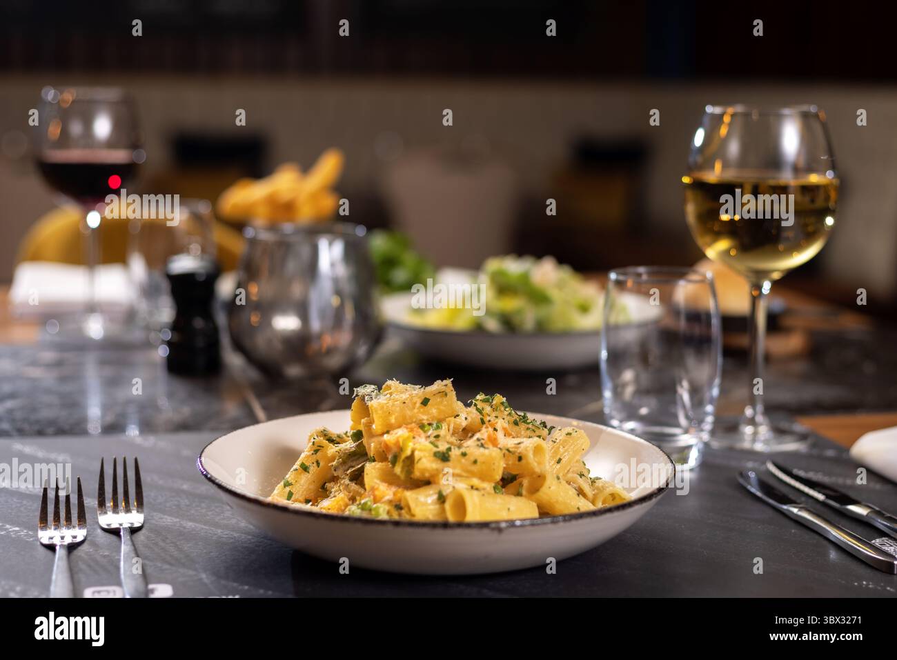 Elegant Italian pasta rigatoni with herbs and cheese at a fine dining ...