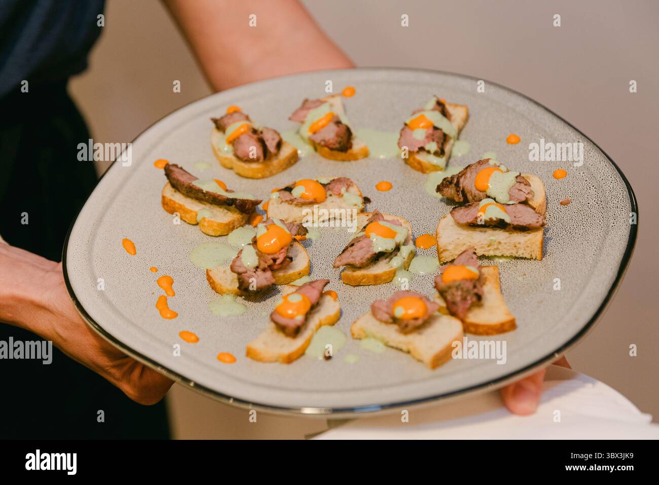 A chef showcases a colorful platter of savory appetizers with diverse ...