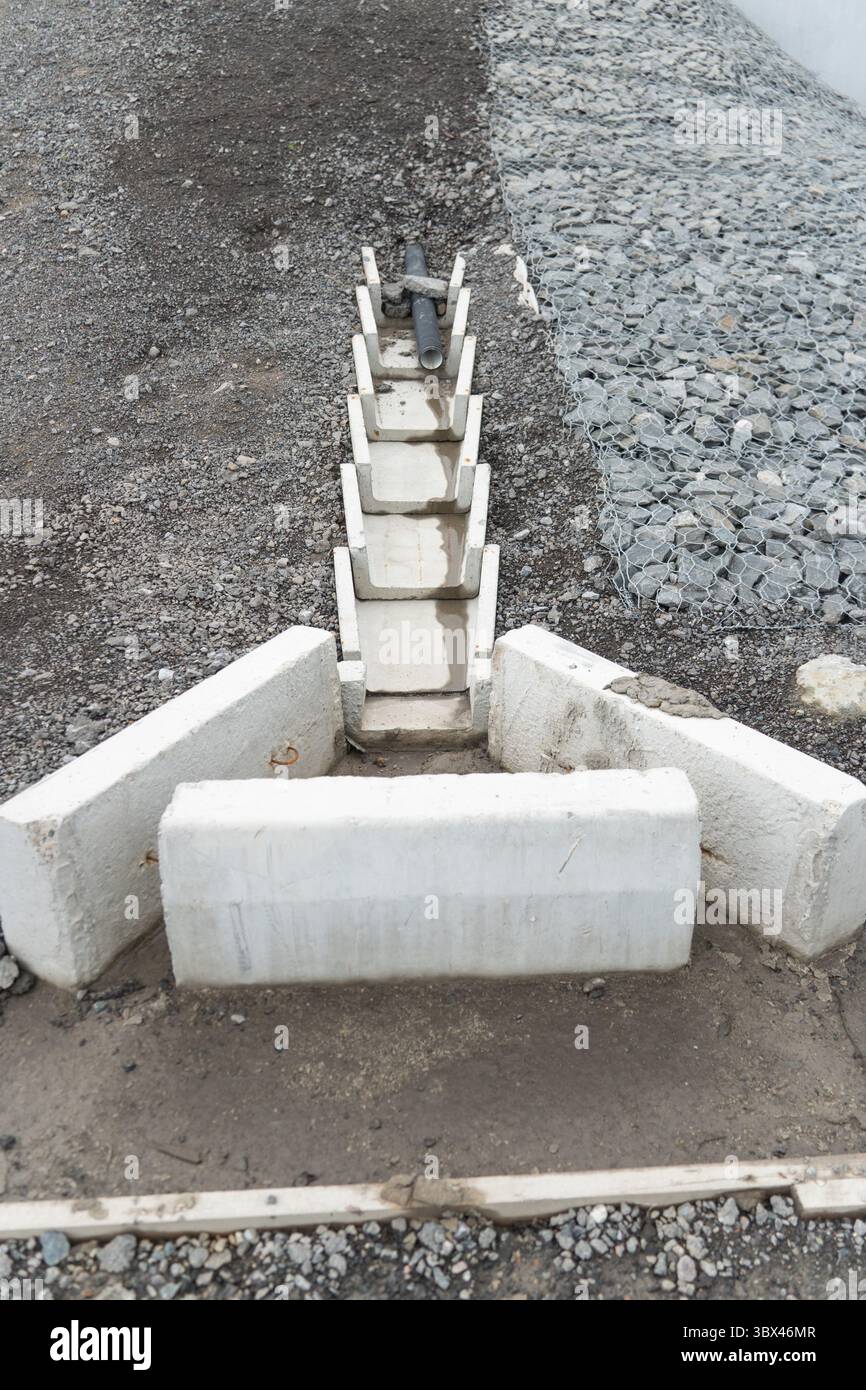 Concrete drainage channel with embedded plastic pipe for stormwater ...