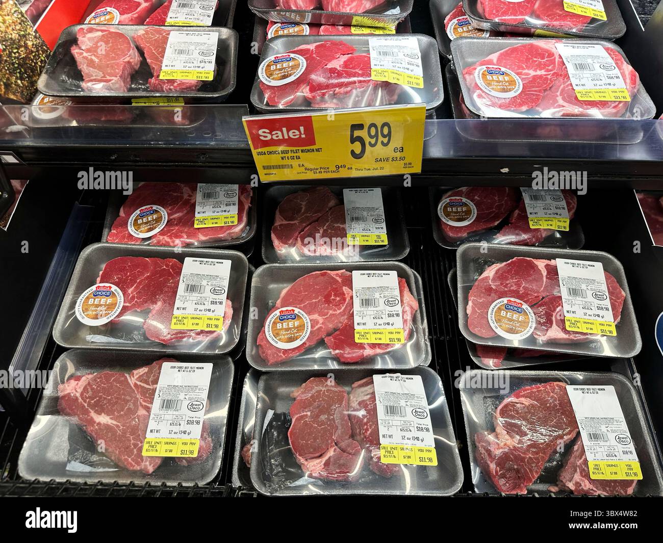 A price for beef is displayed on the edge of a shelf at a grocery store ...