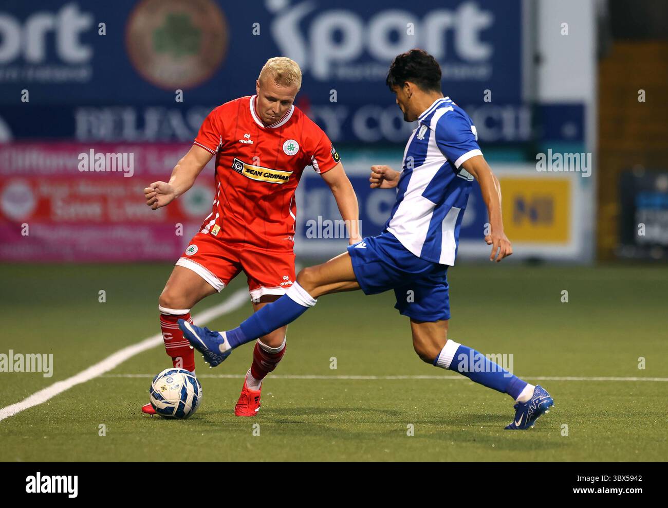 Cliftonville's Conor Pepper (left) and St Joseph's Facundo Alvarez ...