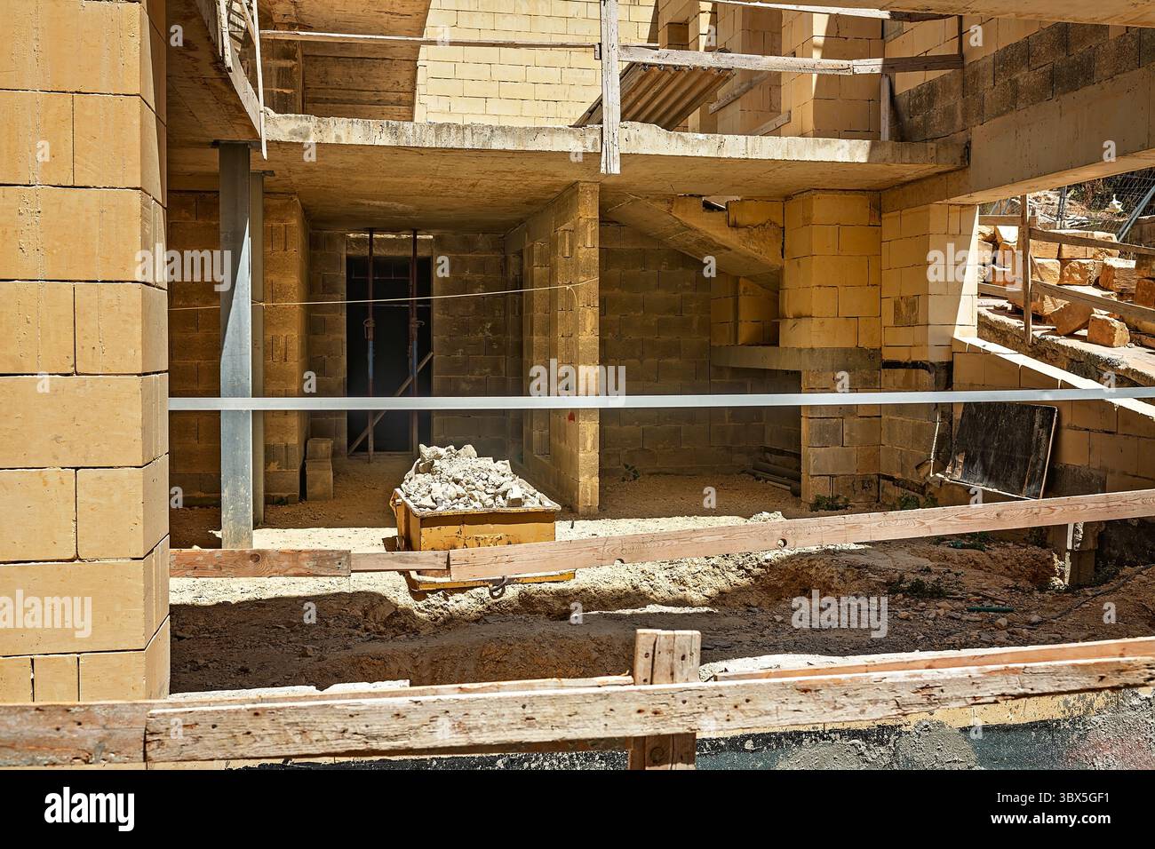 Partially built structure with stairs, room dividers, window and door ...