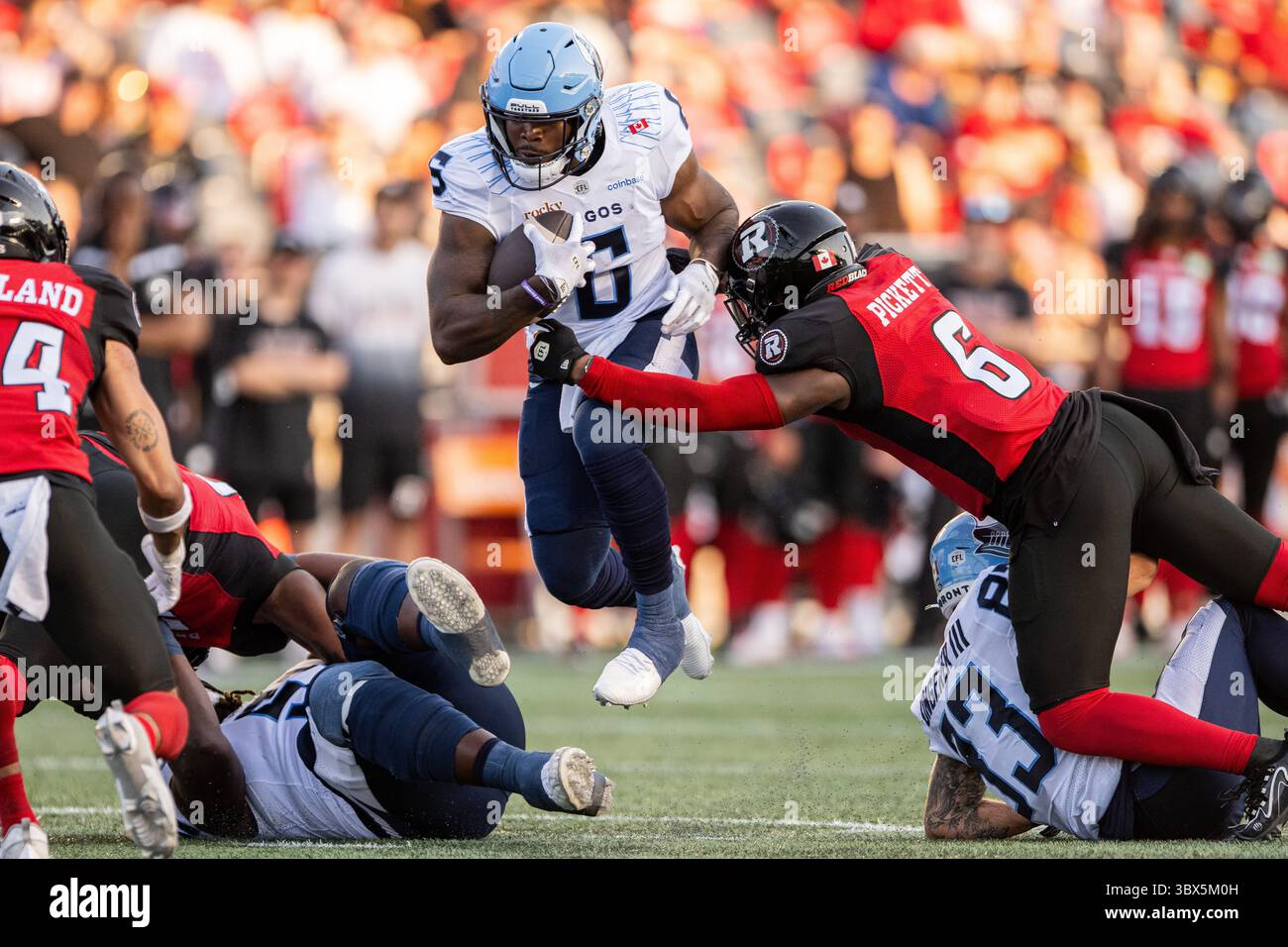 Toronto Argonauts running back Kevin Brown (6) jumps in the air as ...