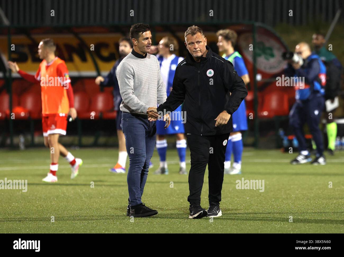 St Joseph's manager Abraham Paz greets Cliftonville manager Jim ...