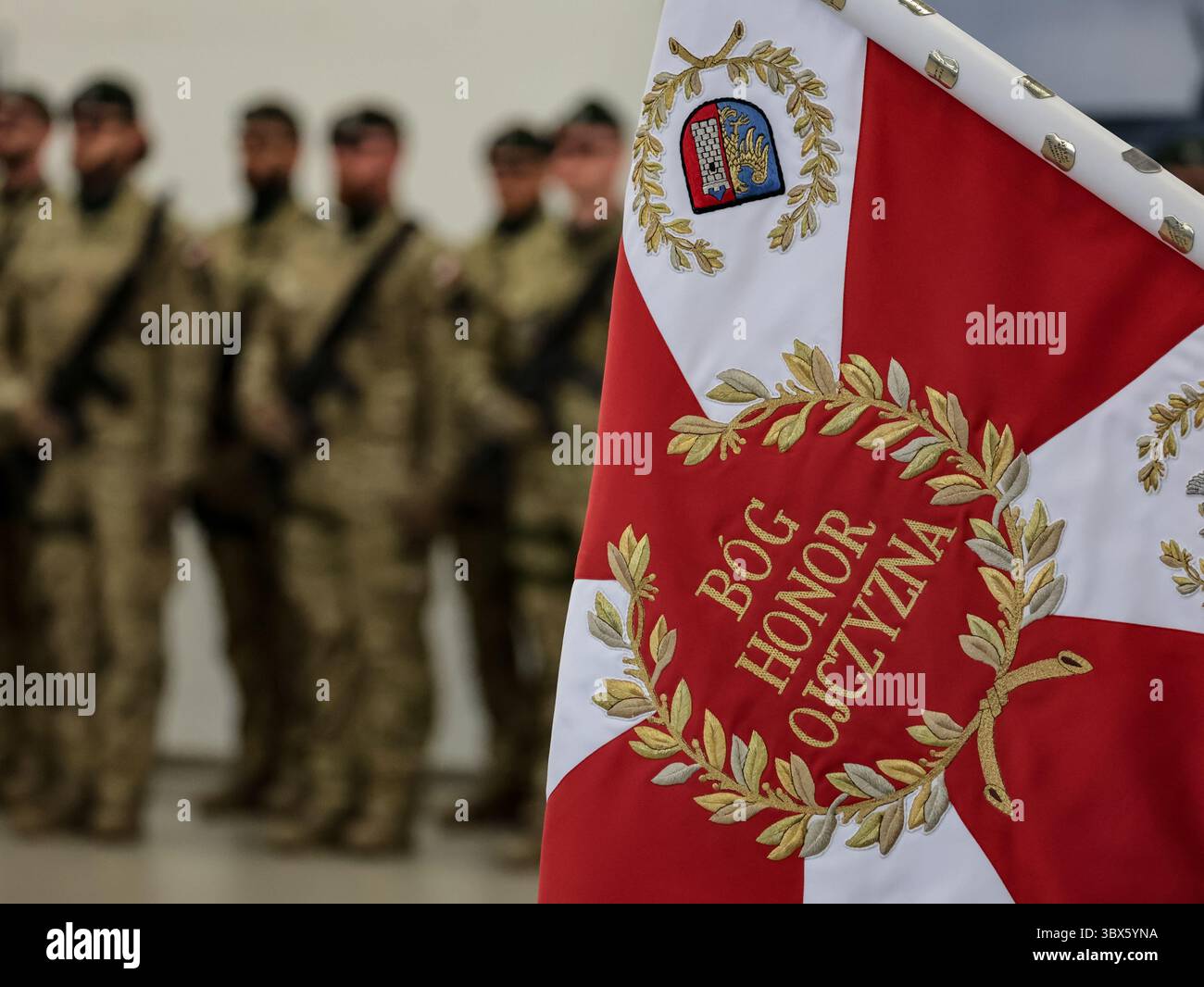Polish serviceman holds a unit banner that say God Honor Matherland as ...