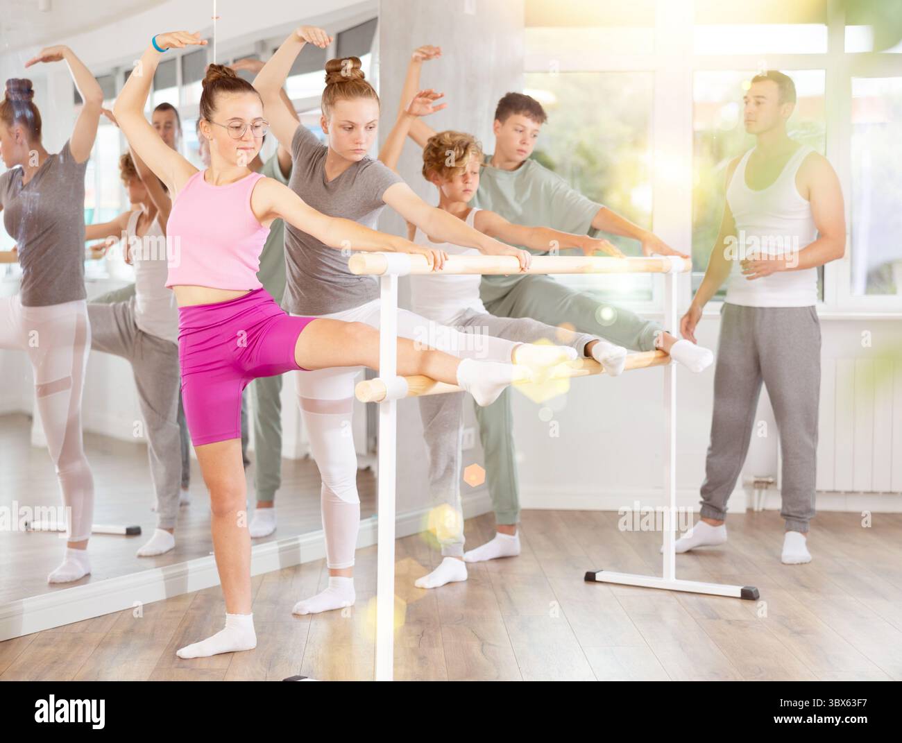 Ballet pose grand batman - girls and boys at a choreography lesson are ...
